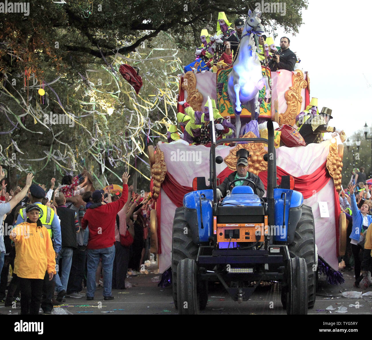 Float riders in the Krewe of Bacchus Mardi Gras parade toss beads to ...