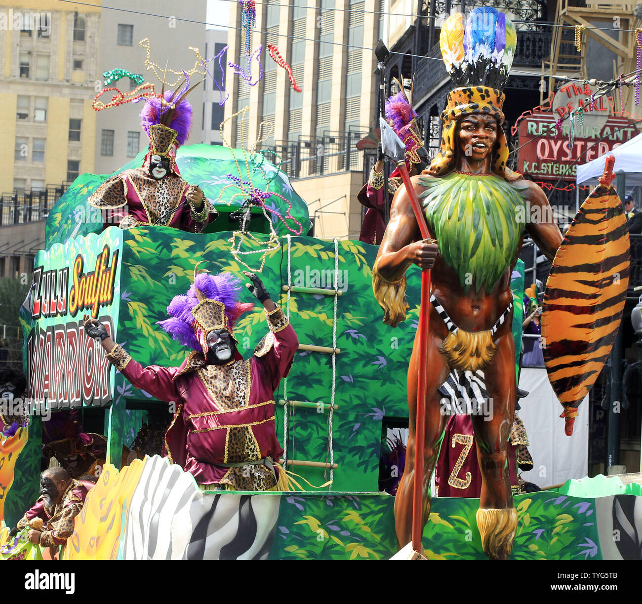 Float riders in the Zulu parade toss beads to the crowd on St Charles ...