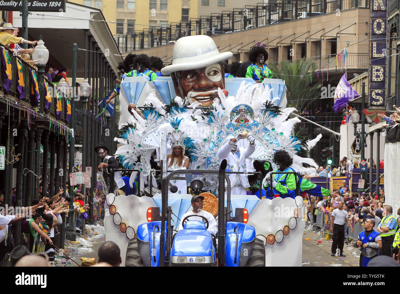 Float riders in the Zulu parade toss beads to the crowd on St Charles ...