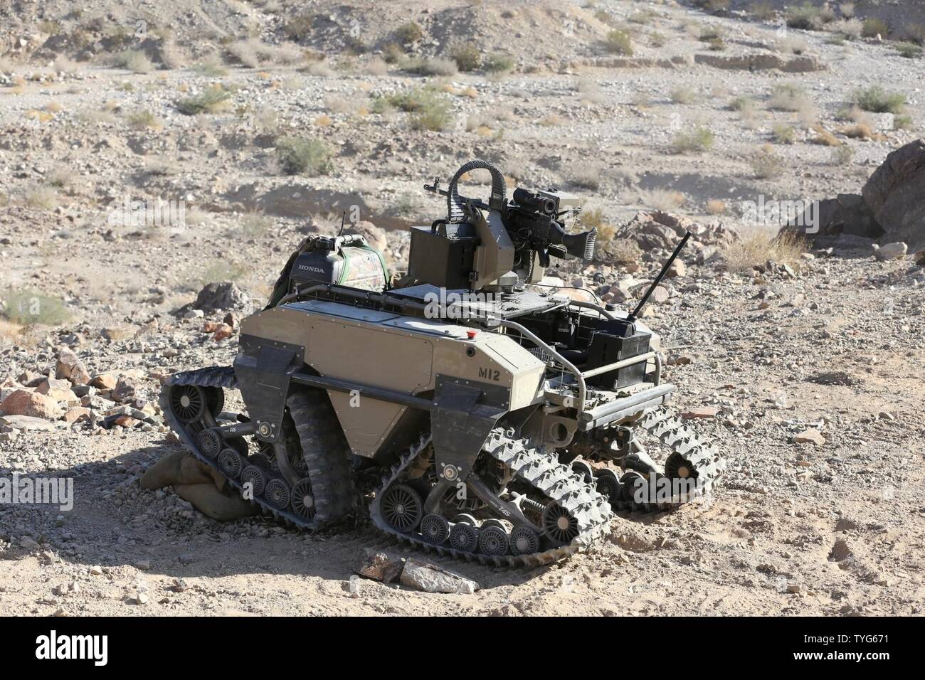 A Weaponized Multipurpose Unmanned Tactical Transport (W-MUTT) provides ...