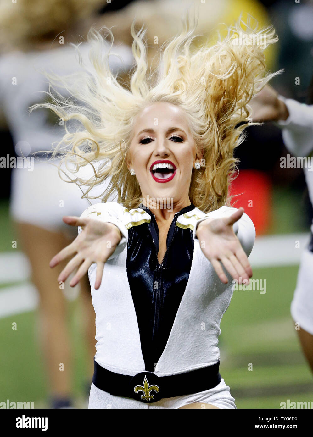 A New Orleans Saints cheerleader entertains the crowd during the game ...