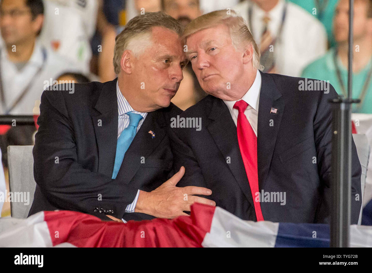 President Donald Trump listens to Virginia Gov. Terry McAuliffe, left ...
