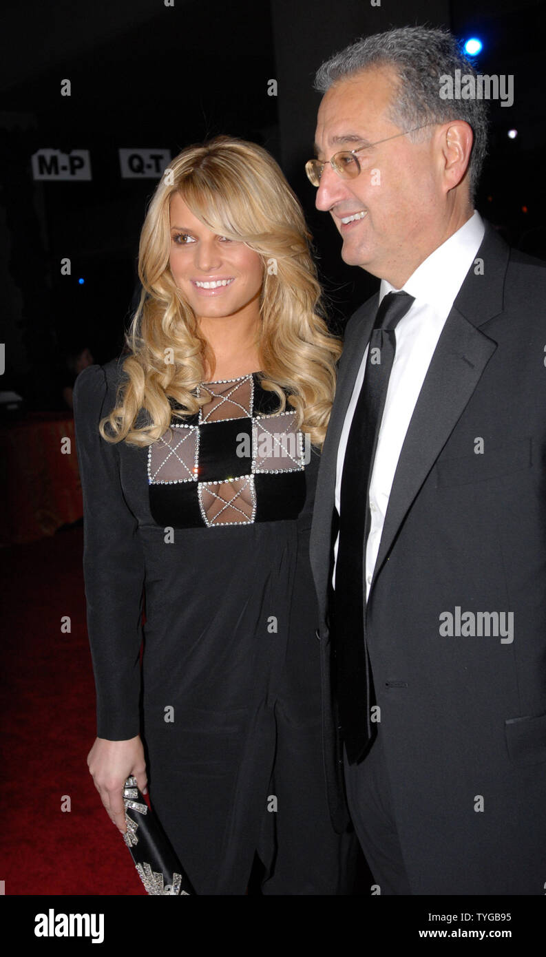 Jessica Simpson (L) poses with BMI President and CEO Del Bryant as she ...