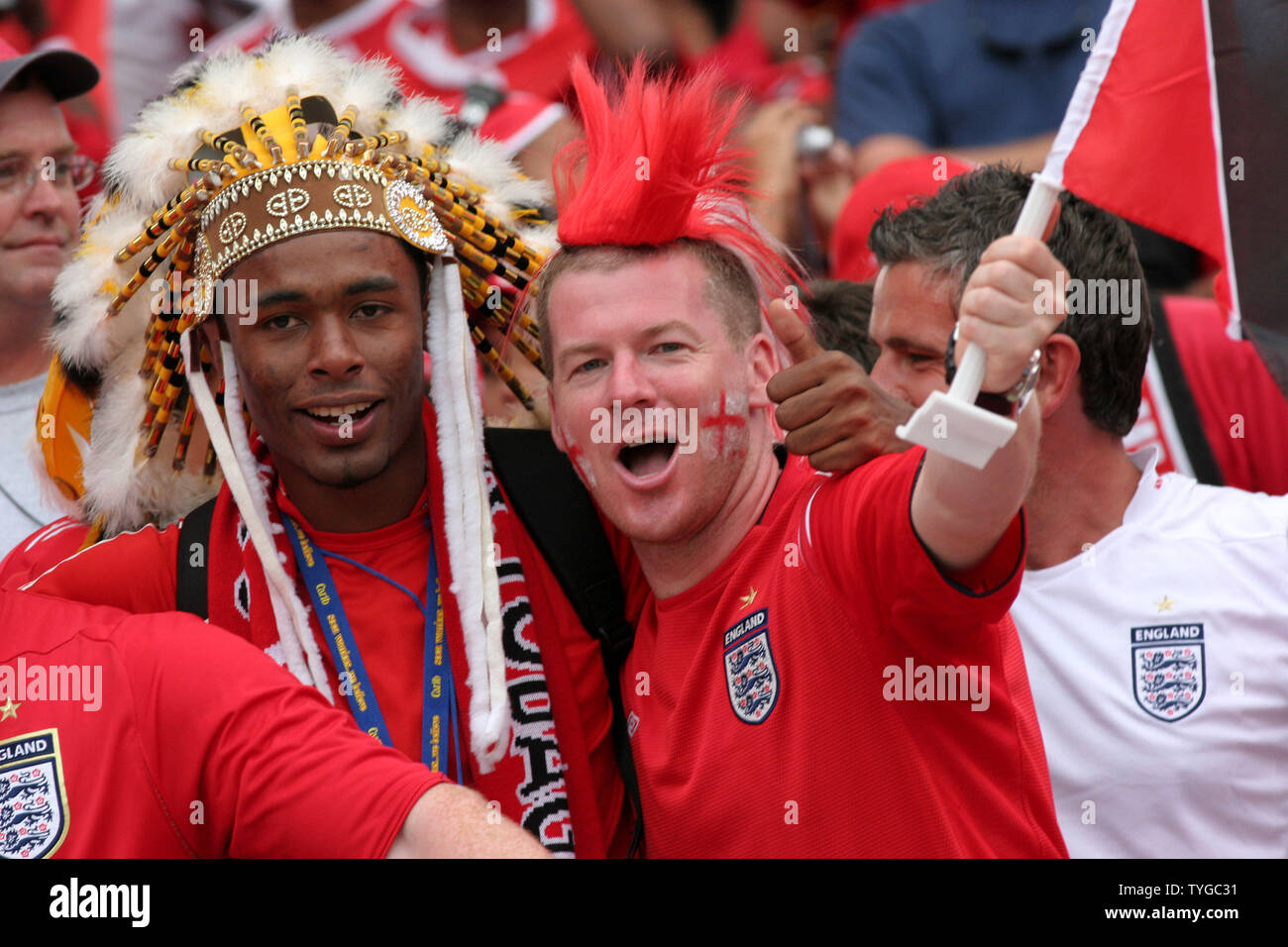 Football fans from England and Trinidad & Tobago celebrate together ...