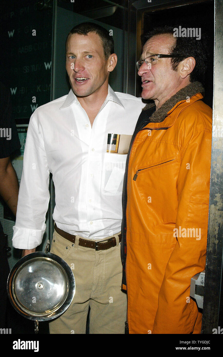 Lance Armstrong (left) and Robin Williams pose for pictures at the Men ...