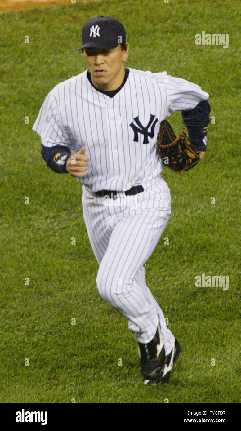New York Yankee's outfielder Hideki Matsui heads back to the dugout ...
