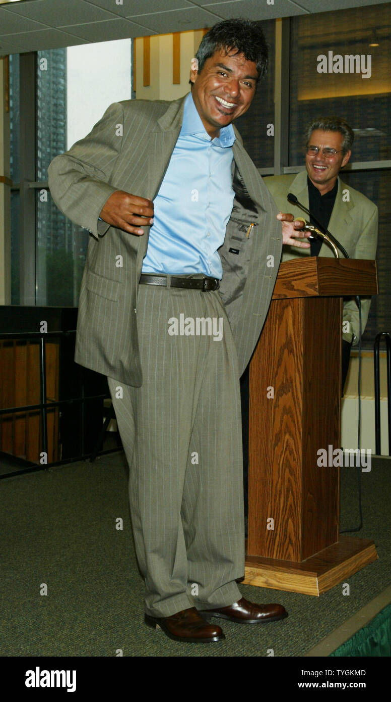 George Lopez poses for pictures before signing copies of his new book ...