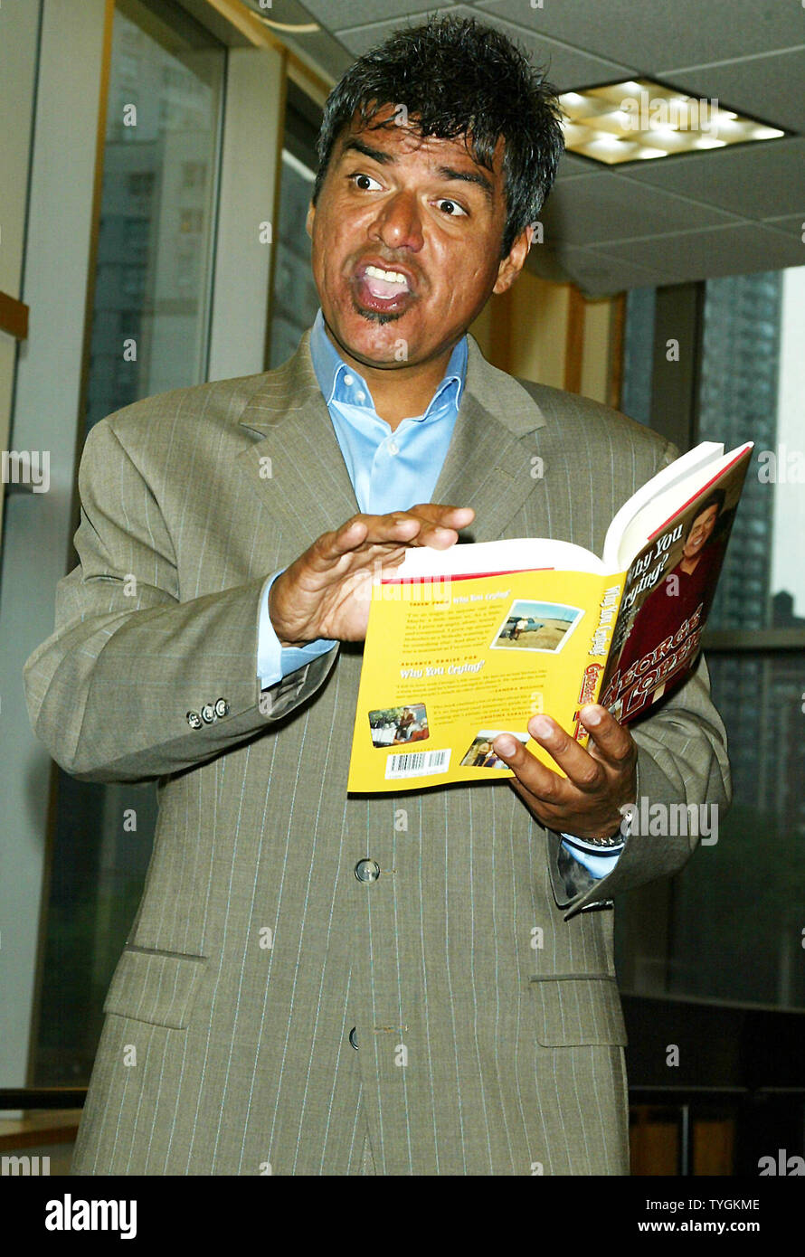 George Lopez poses for pictures before signing copies of his new book ...