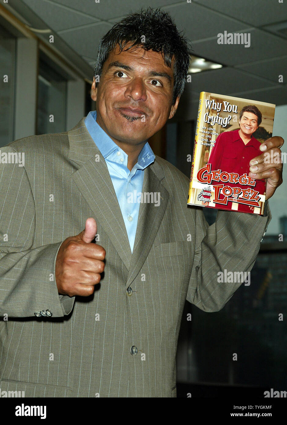 George Lopez poses for pictures before signing copies of his new book ...