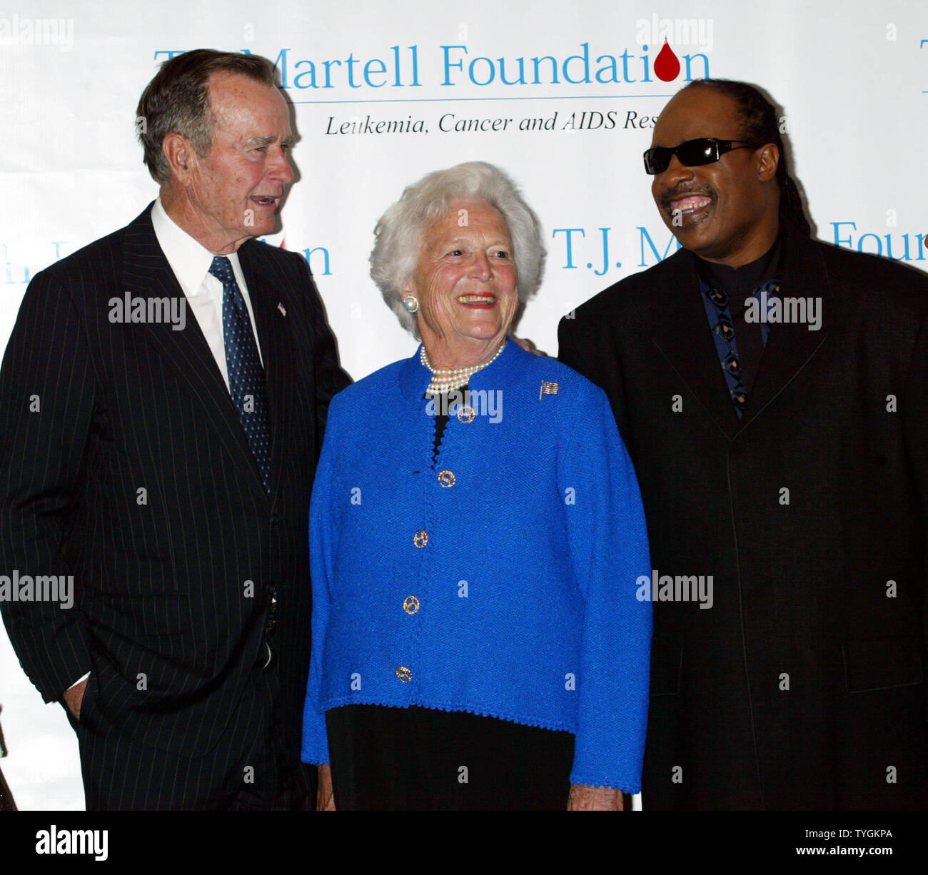 George and Barbara Bush and Stevie Wonder pose for pictures at the T.J ...