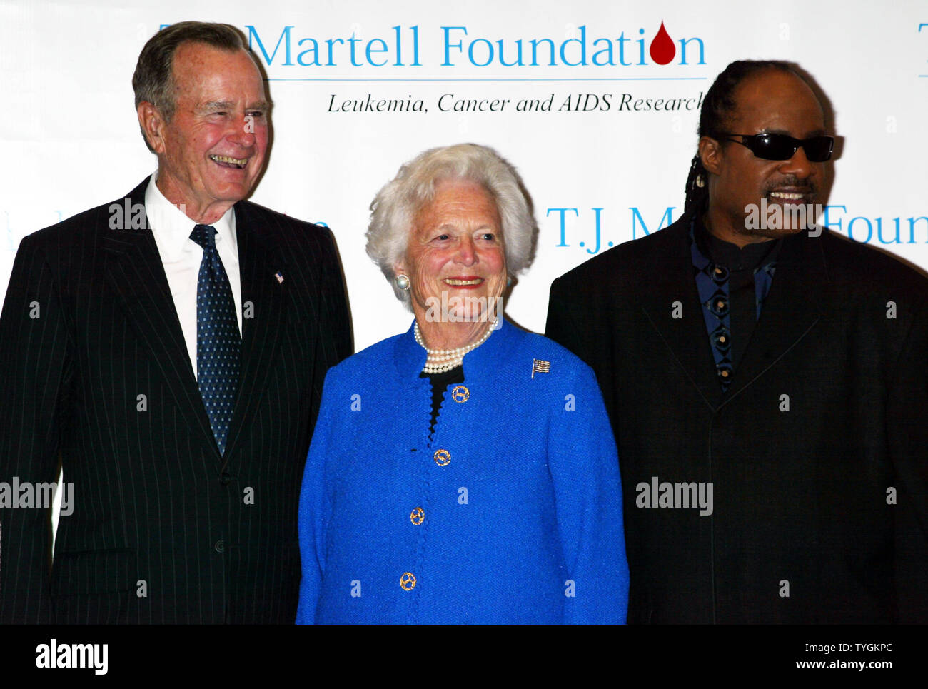 George and Barbara Bush and Stevie Wonder pose for pictures at the T.J ...