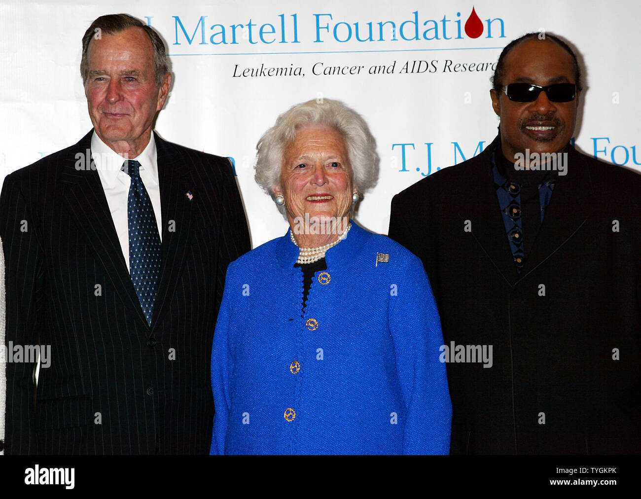 George and Barbara Bush and Stevie Wonder pose for pictures at the T.J ...