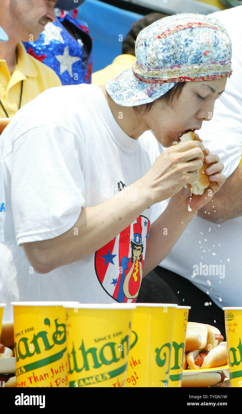 Champion Takeru Kobayashi forces down a water soaked bun. Japanese ...
