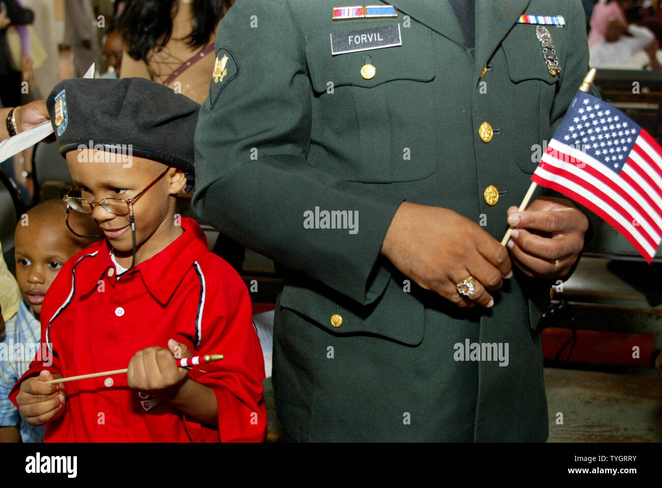 Karim Forvil, 5, wears his father's hat after his dad Marcus of Haiti ...
