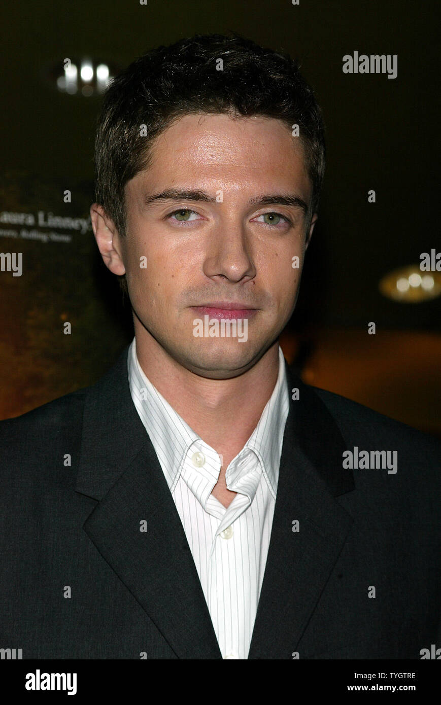 Topher Grace poses for pictures at the premiere of "p.s." at the ...