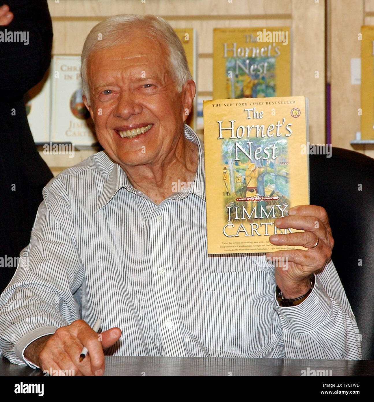 Former U.S. President Jimmy Carter shows off his latest written work of ...
