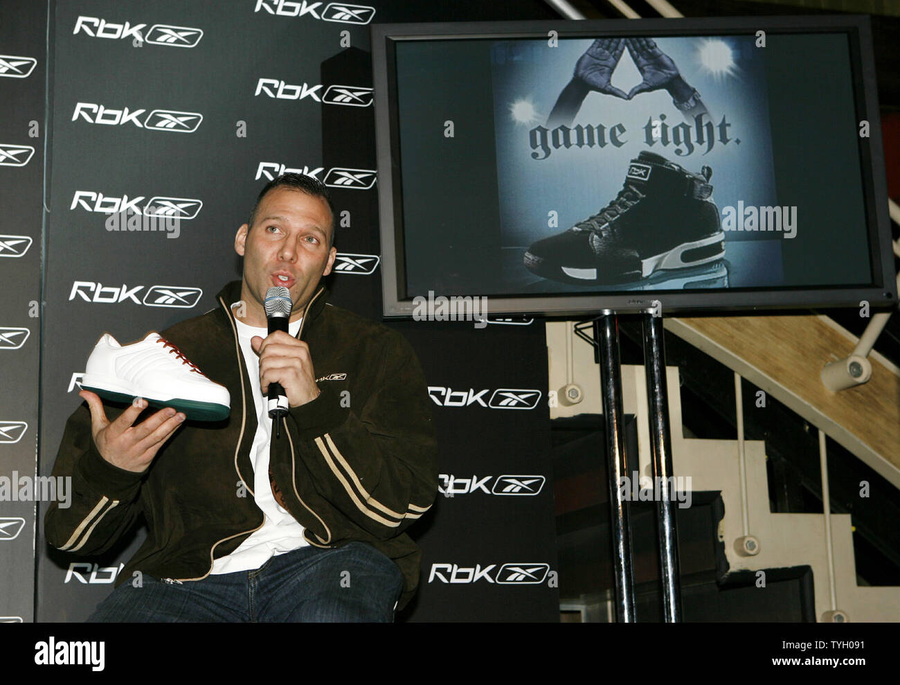 Todd Krinsky raises up a sneaker at the Reebok RBK Now Playing press ...