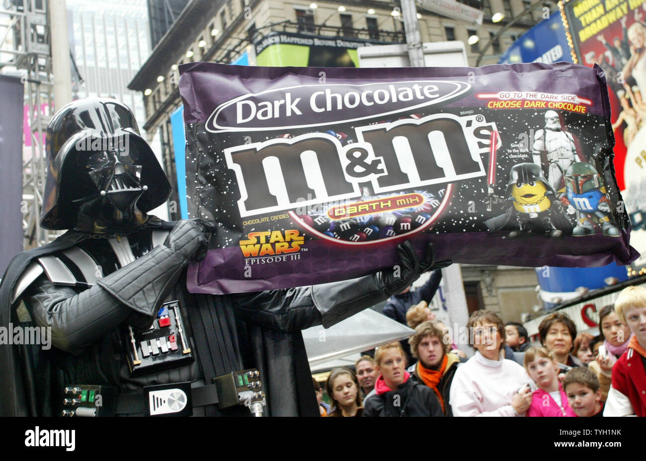 Star Wars character Darth Vader holds up a model of the new Star War ...