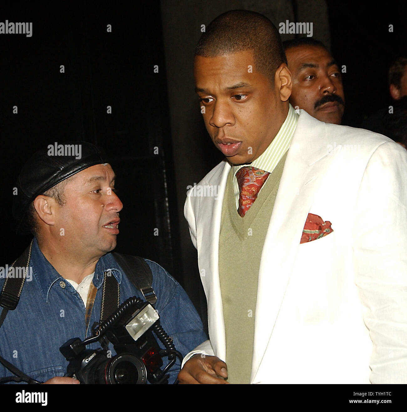Rapper Jay Z makes his way past photographers while attending the April ...
