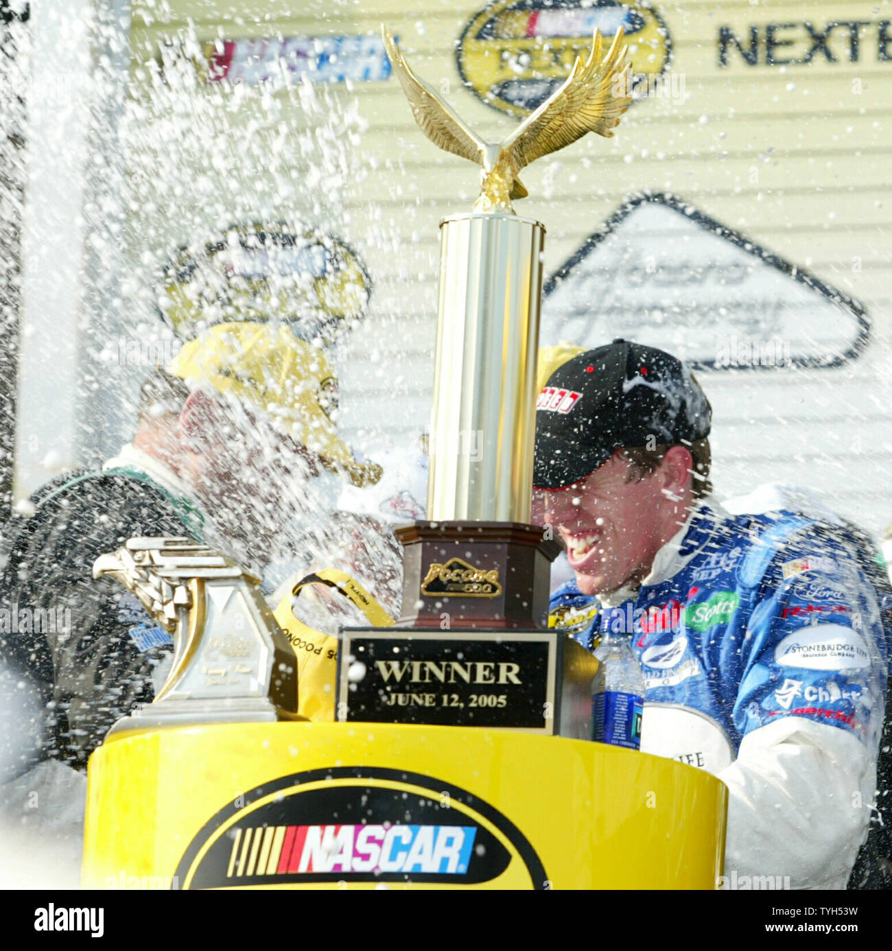 Carl Edwards celebrates with champagne after winning at NASCAR's Pocono ...