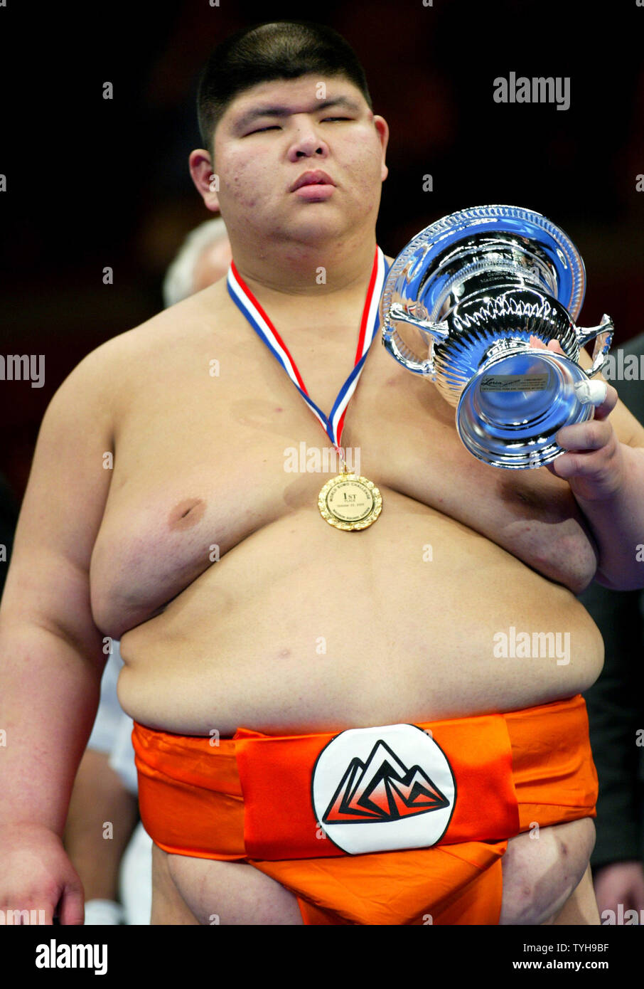 Mitshuhiko Fukao of Japan holds the trophy he earned after winning the ...