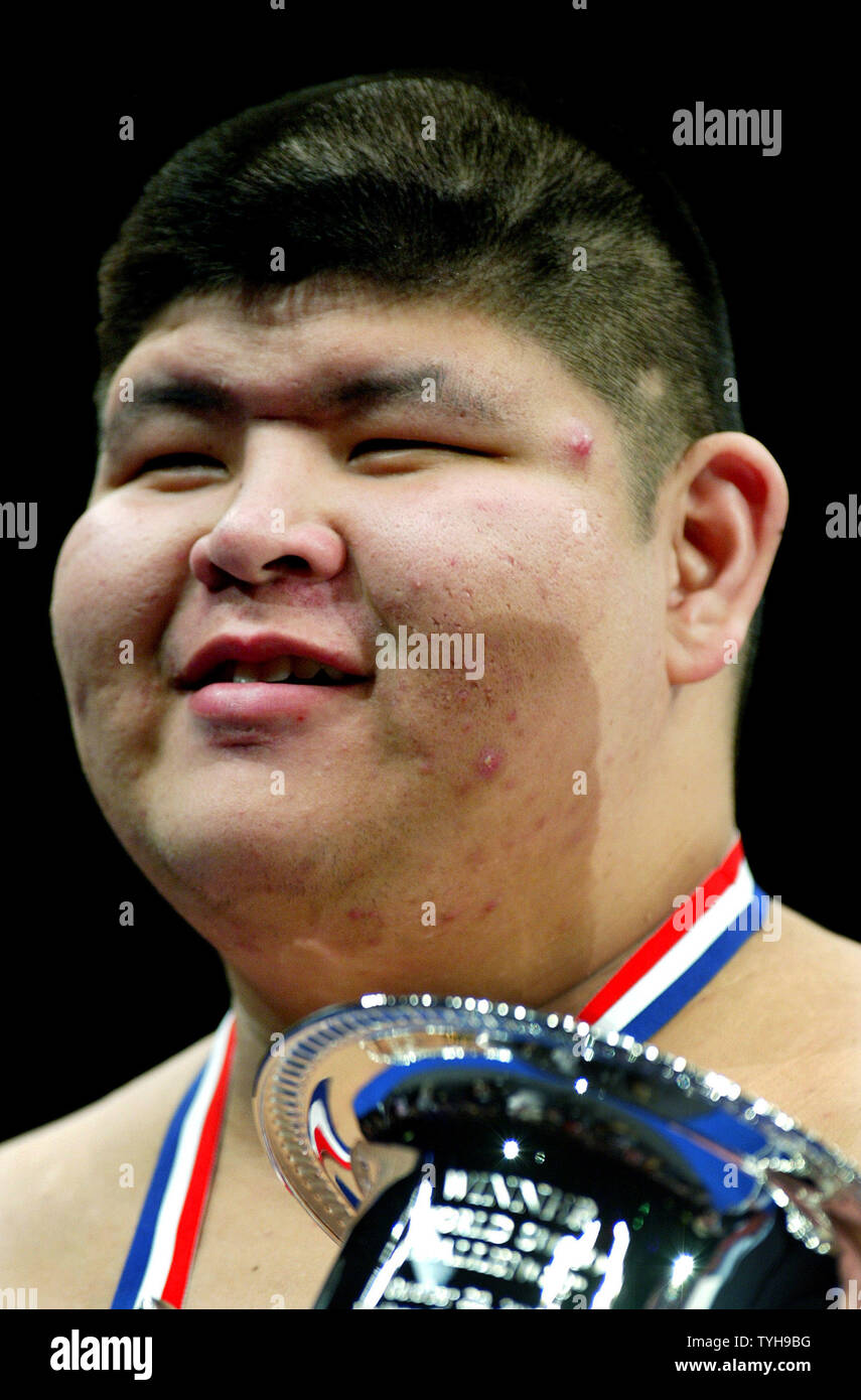 Mitshuhiko Fukao of Japan holds the trophy he earned after winning the ...