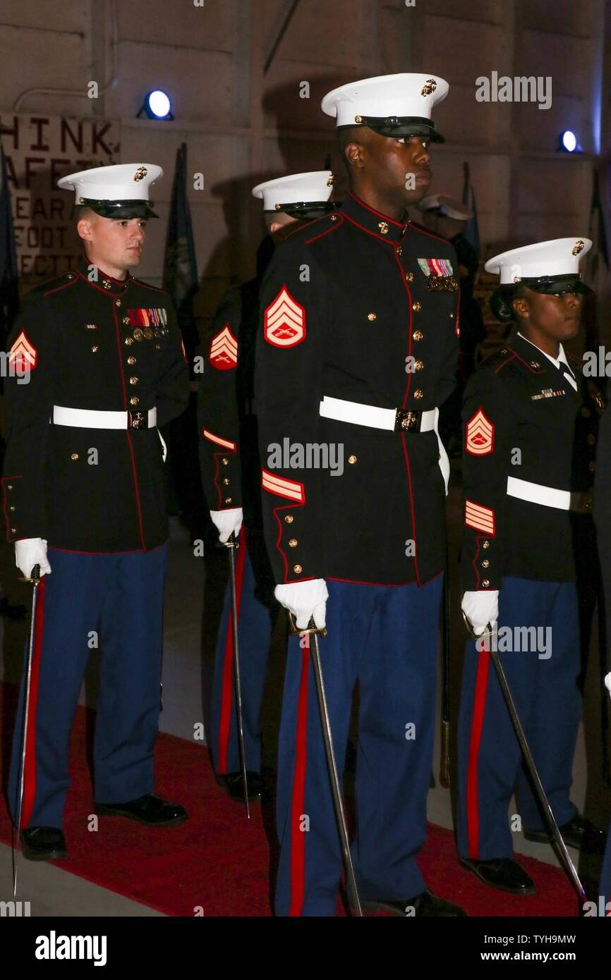 Four enlisted Marines stand at parade rest in a formation at Marine ...