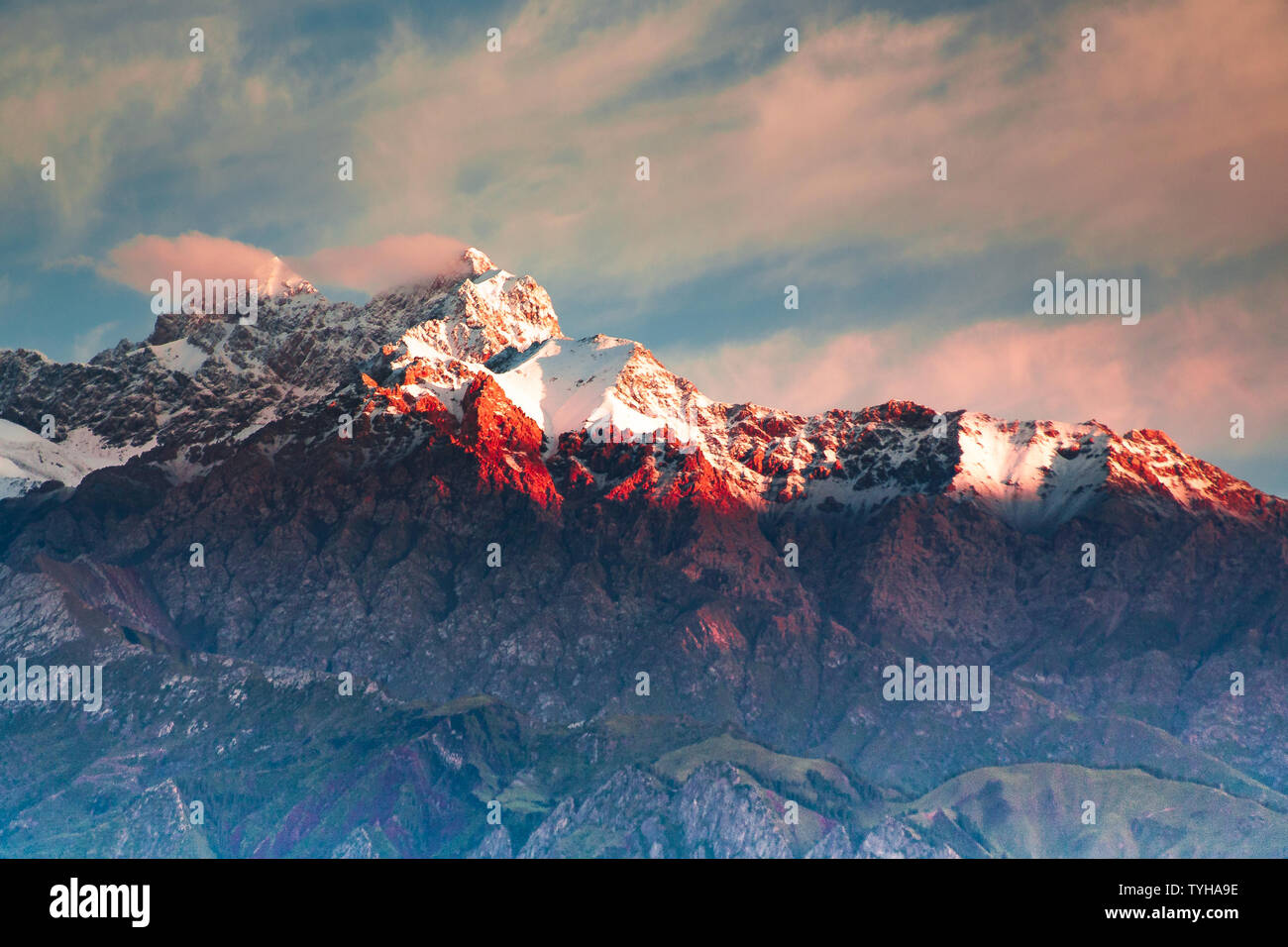 The early morning sun illuminates the snow peak in the Tomur Peak ...