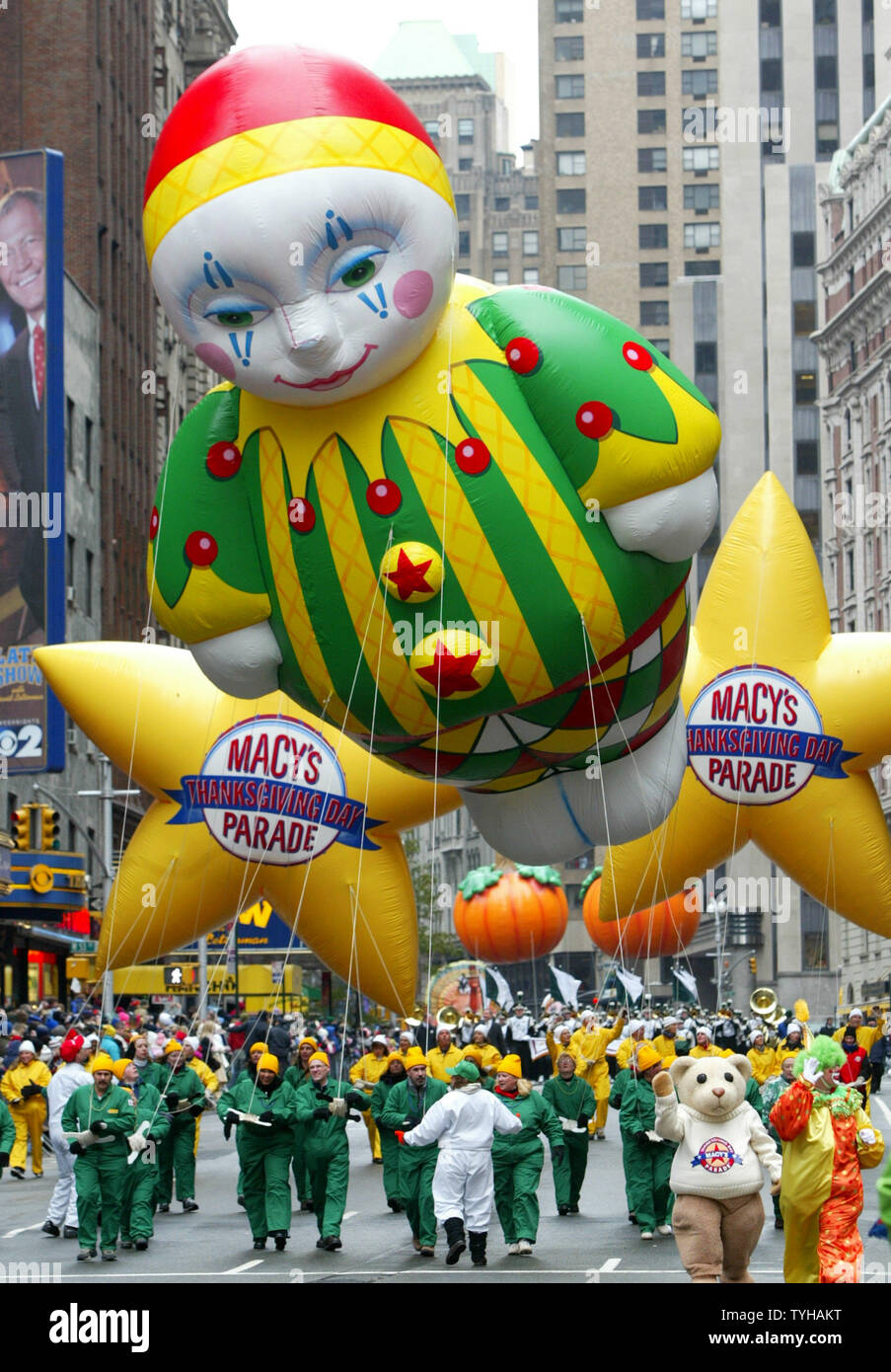 Giant helium balloons are guided down Broadway during the 79th Macy's ...
