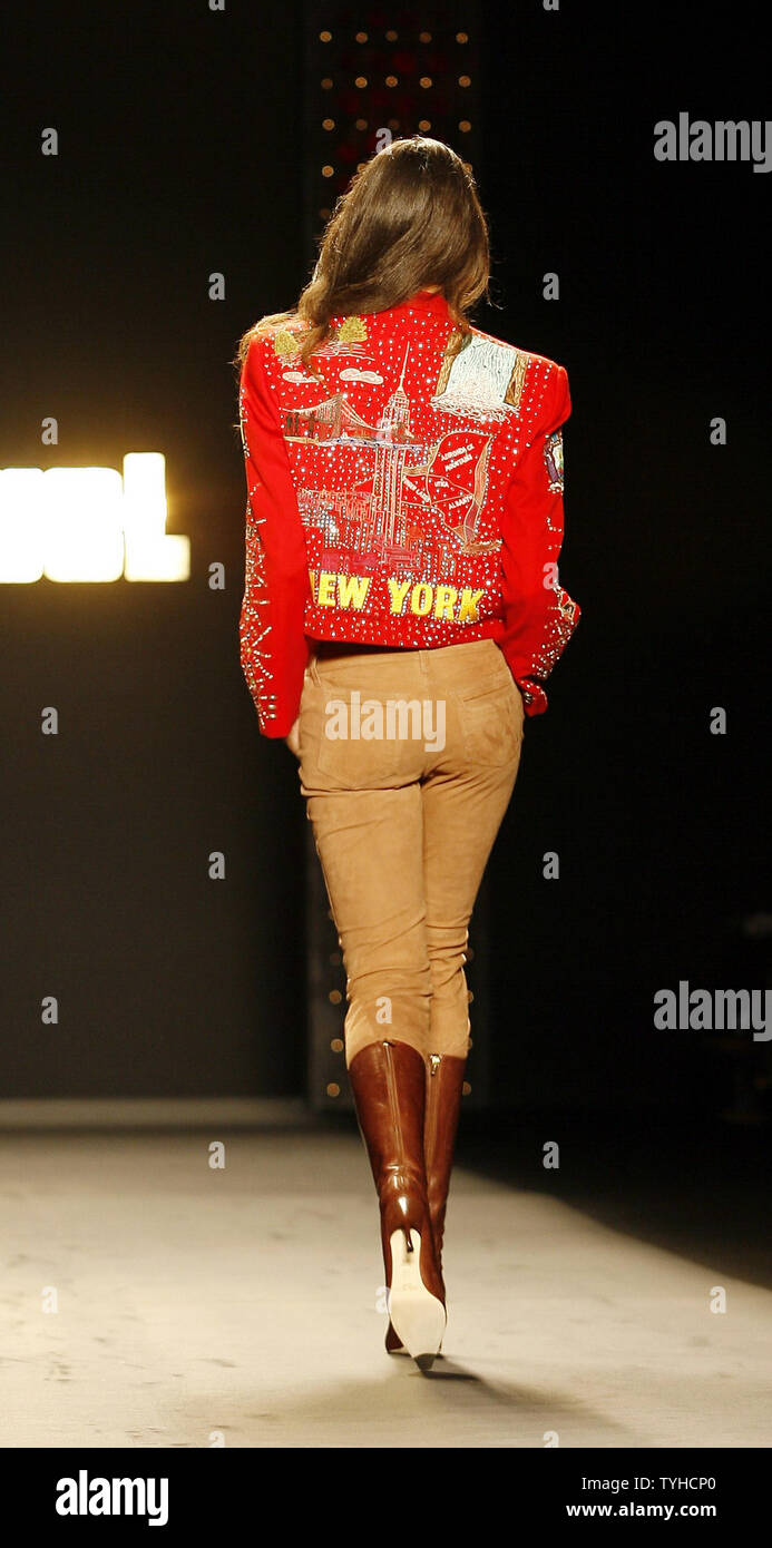 A model with New York on the back of her jacket walks down the runway ...
