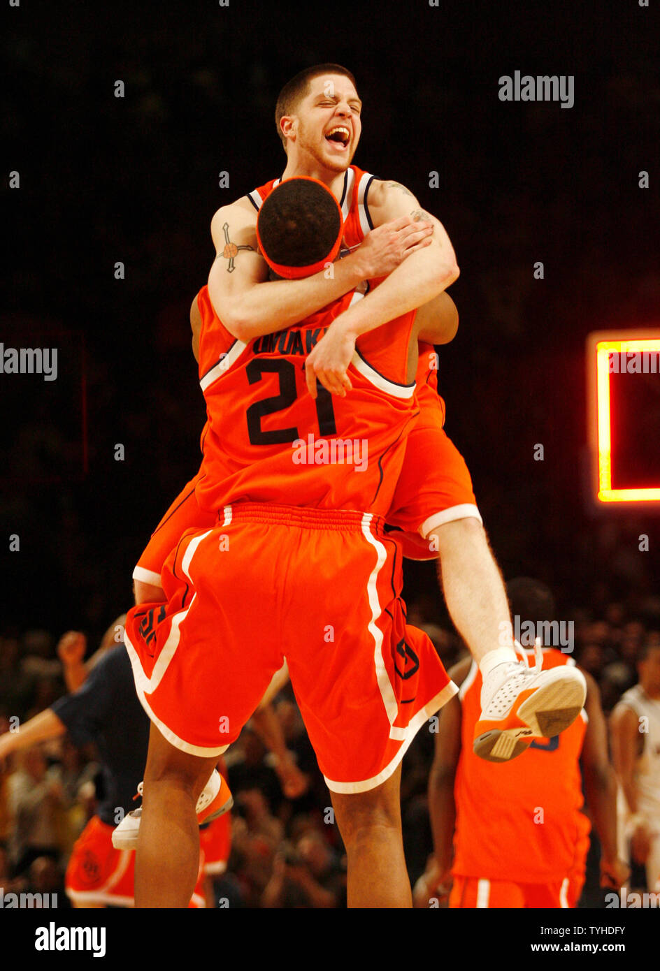 Syracuse guard (23) Eric Devendorf celebrates by jumping into Arinze ...