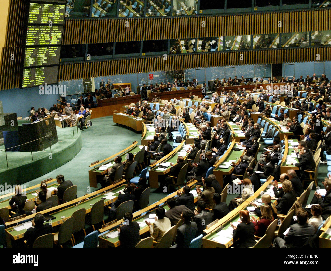The vote tally appears on the giant screen, upper left, after members ...