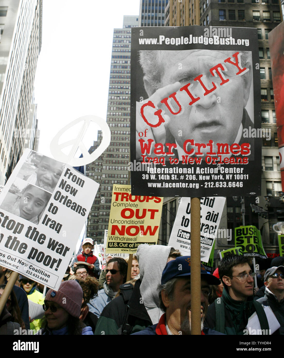 Protesters hold up signs on the third anniversary of the United States ...