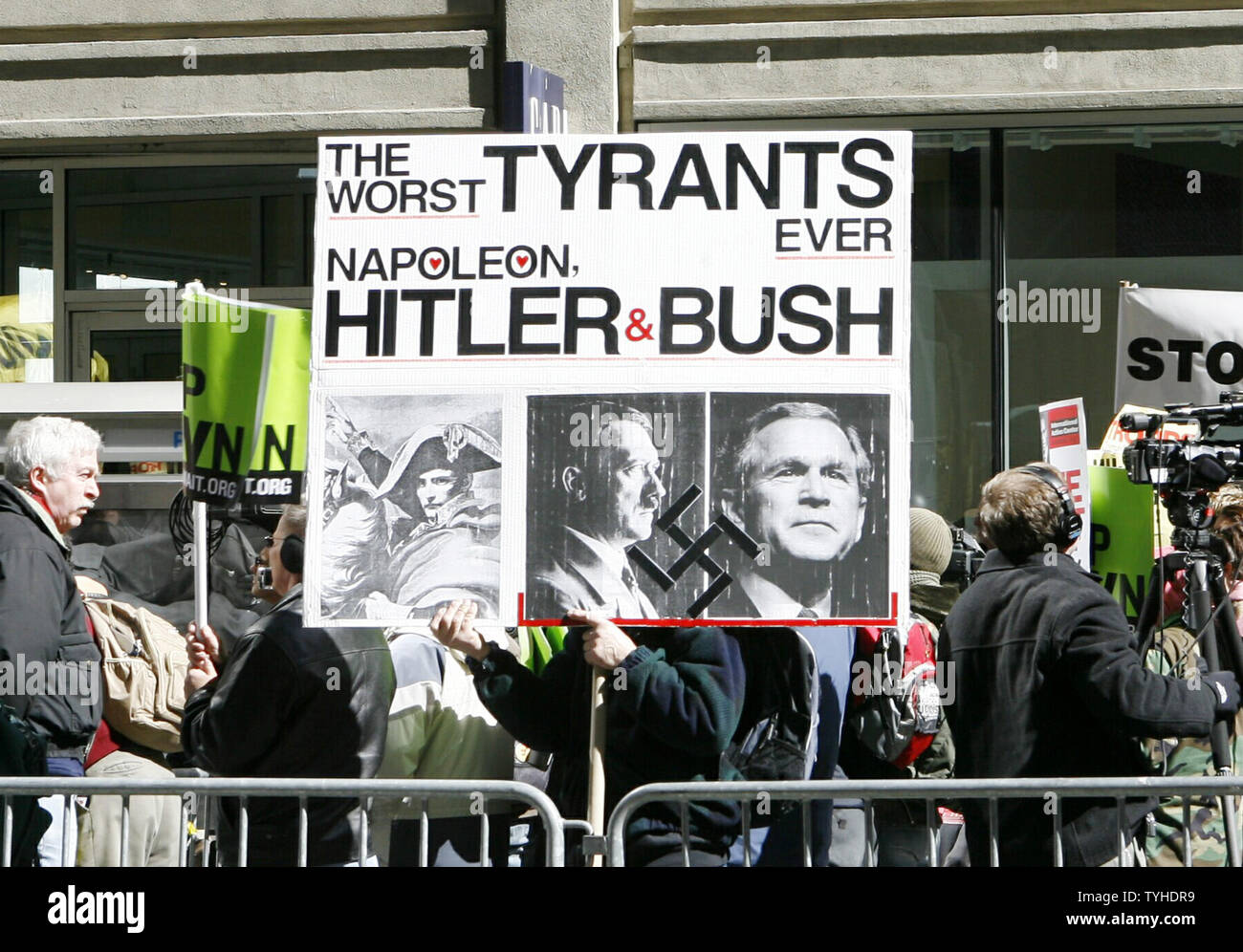 Protesters hold up signs on the third anniversary of the United States ...