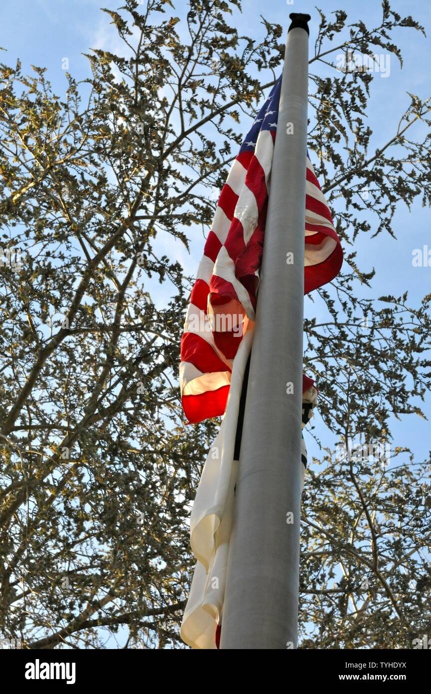 The U.S. flag stands atop the flagpole after being raised at a flag ...