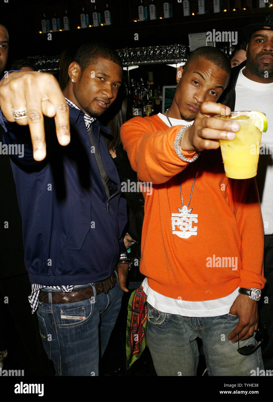 Usher and Tip "T.I." Harris stop and pose for pictures at the premiere ...