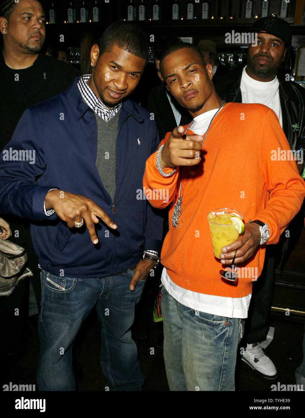 Usher and Tip "T.I." Harris stop and pose for pictures at the premiere ...