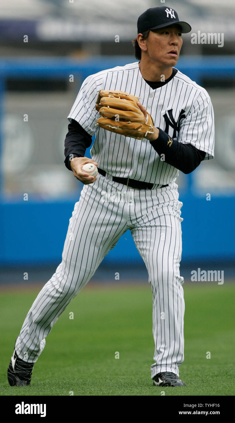 New York Yankees' Hideki Matsui fields the ball from left field in the ...