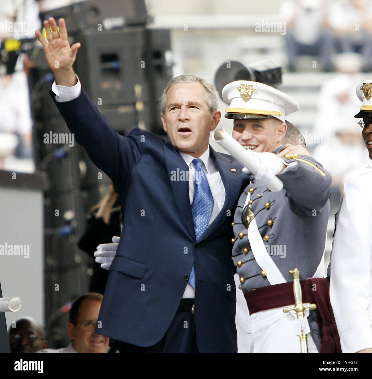 President George W. Bush poses for a Cadets family in the audience at ...