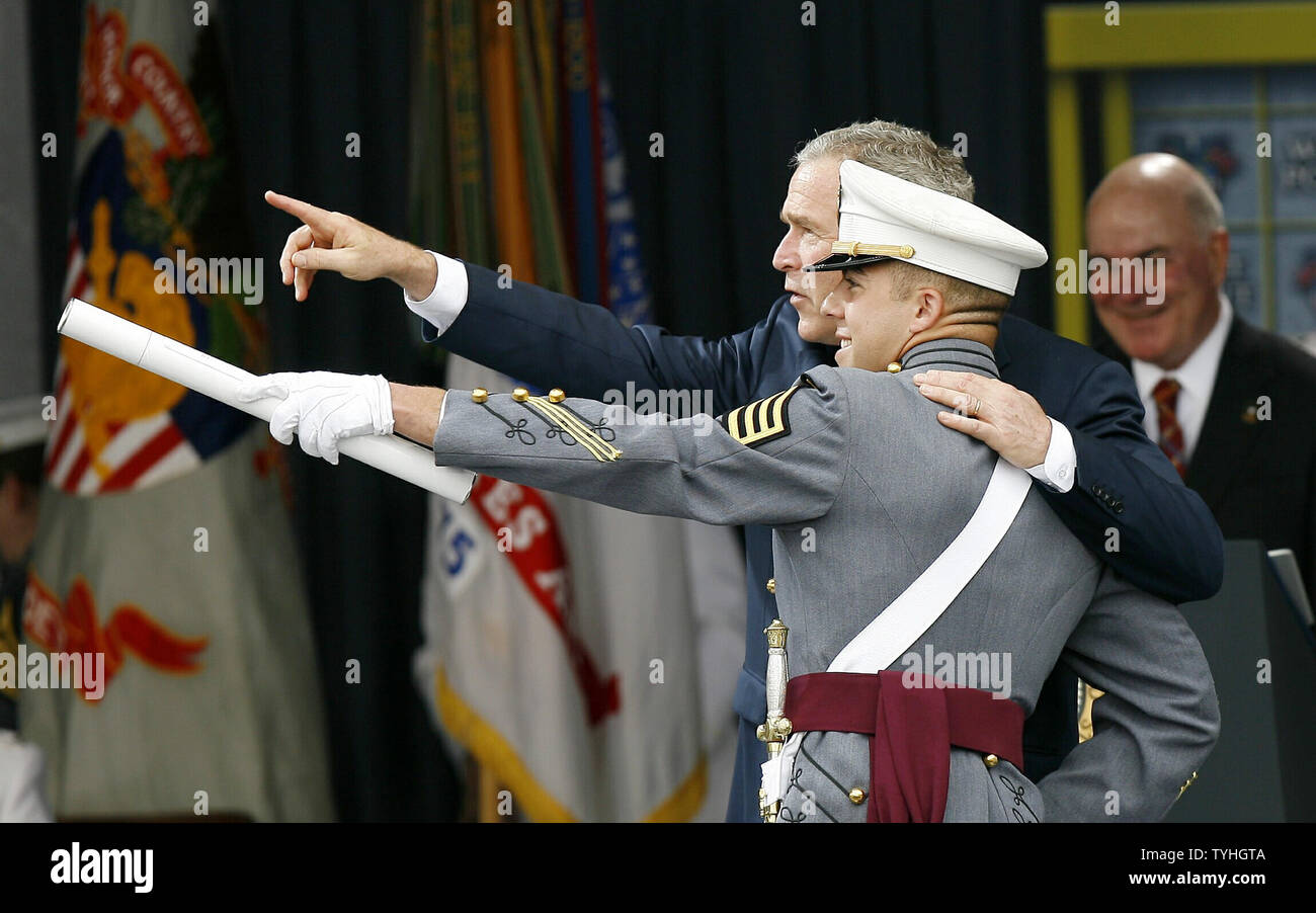 President George W. Bush poses for a cadets family in the audience at ...
