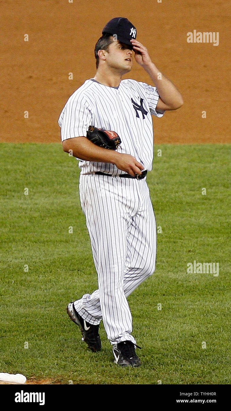 New York Yankees pitcher Jaret Wright reacts with runners on base in ...