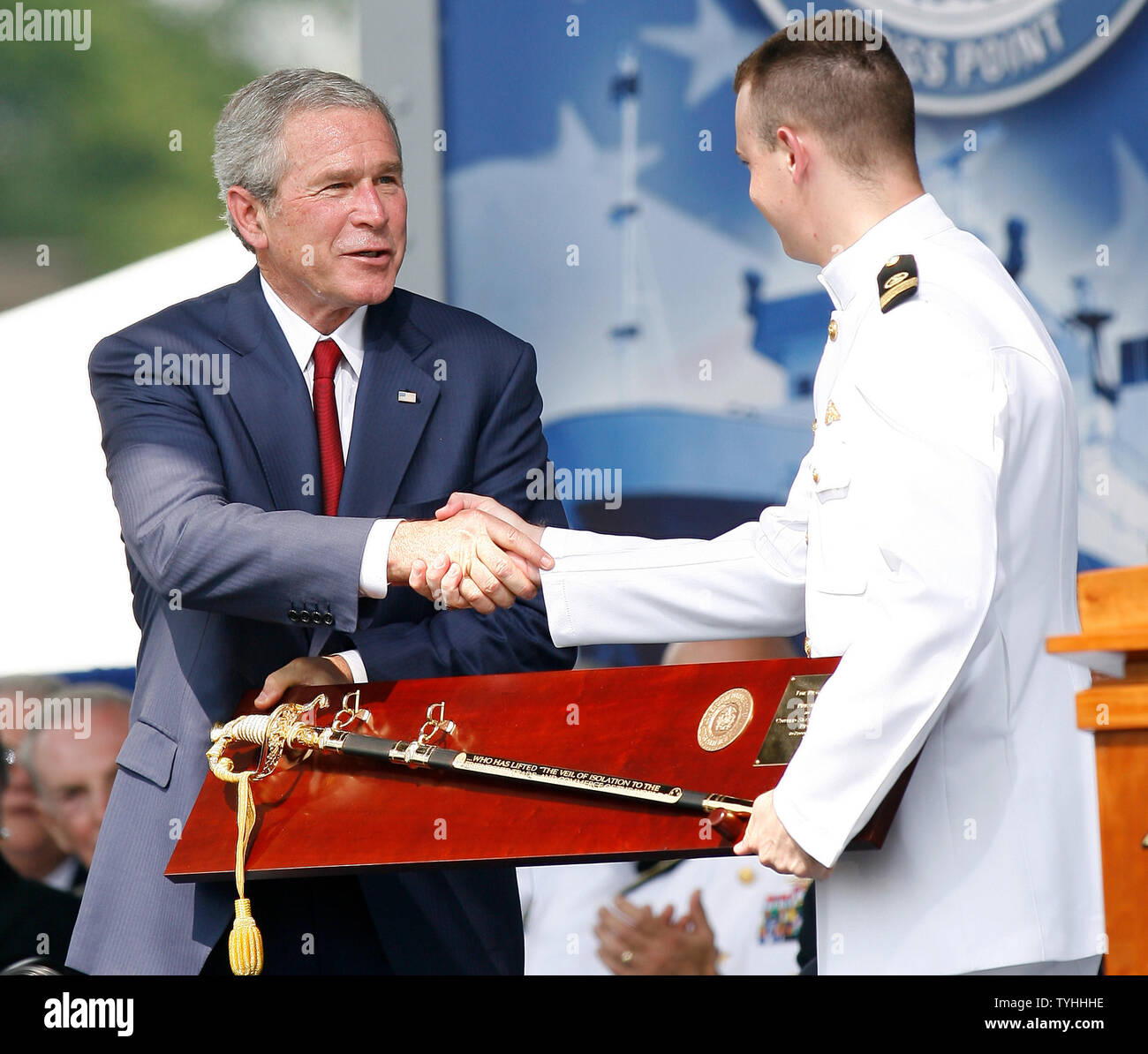 President George W. Bush receives a gift after giving a speech on ...