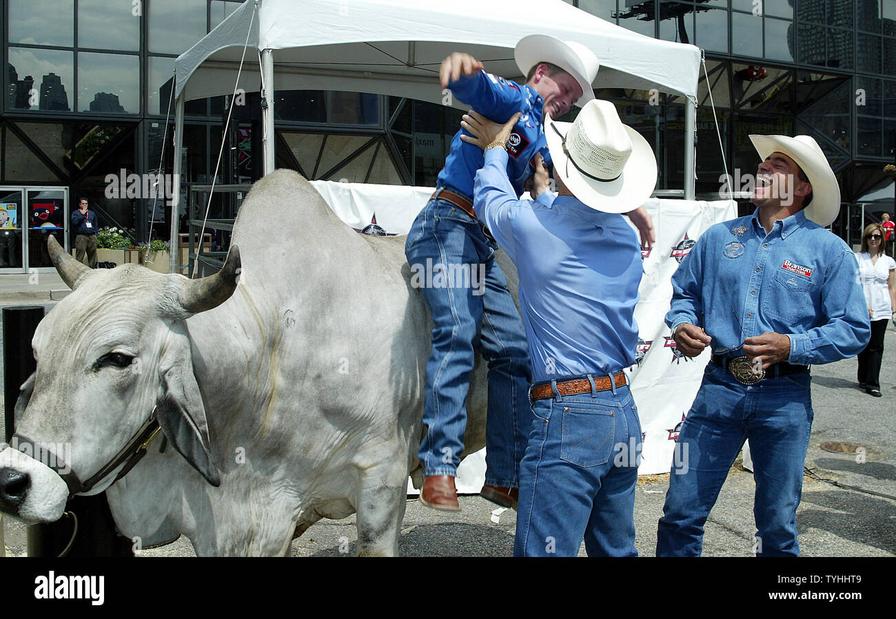 Chris Shivers is helped off of Buck Shot, the bull, by Ty Murray as ...