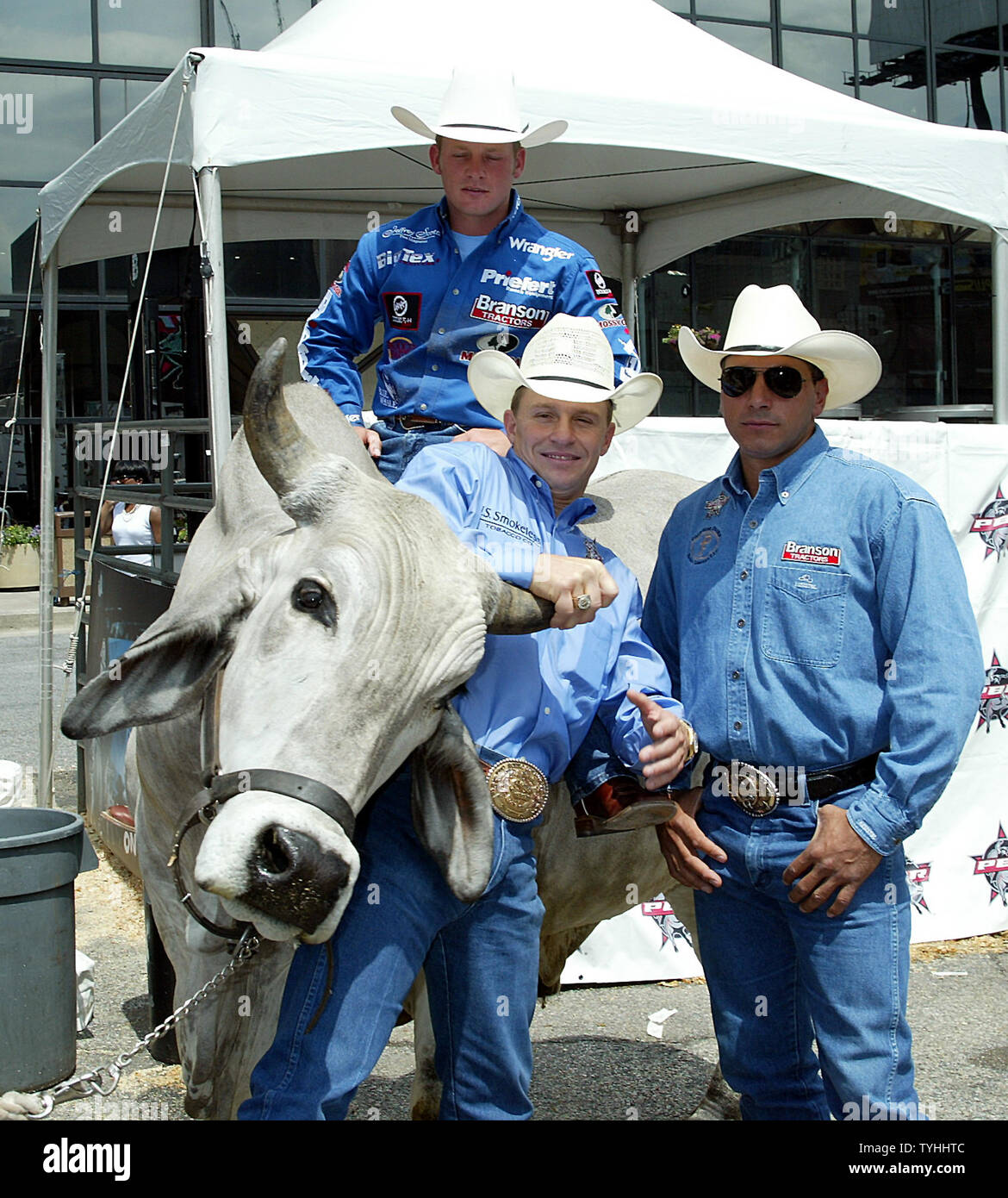 Chris Shivers (on Buck Shot, the bull), Ty Murray and Adriano Moraes ...