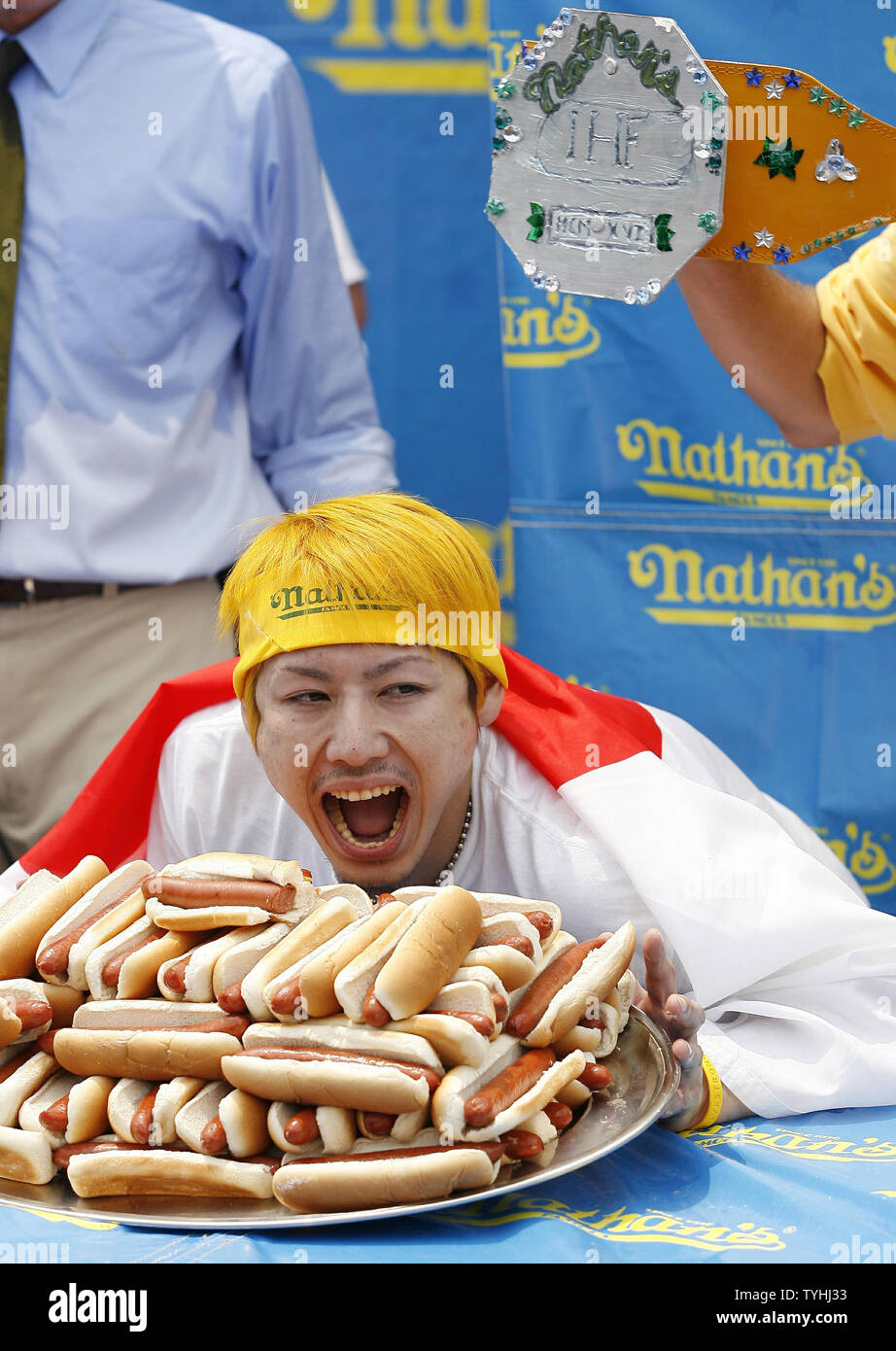 Japanese champion Takeru Kobayashi bends and opens his mouth before a ...