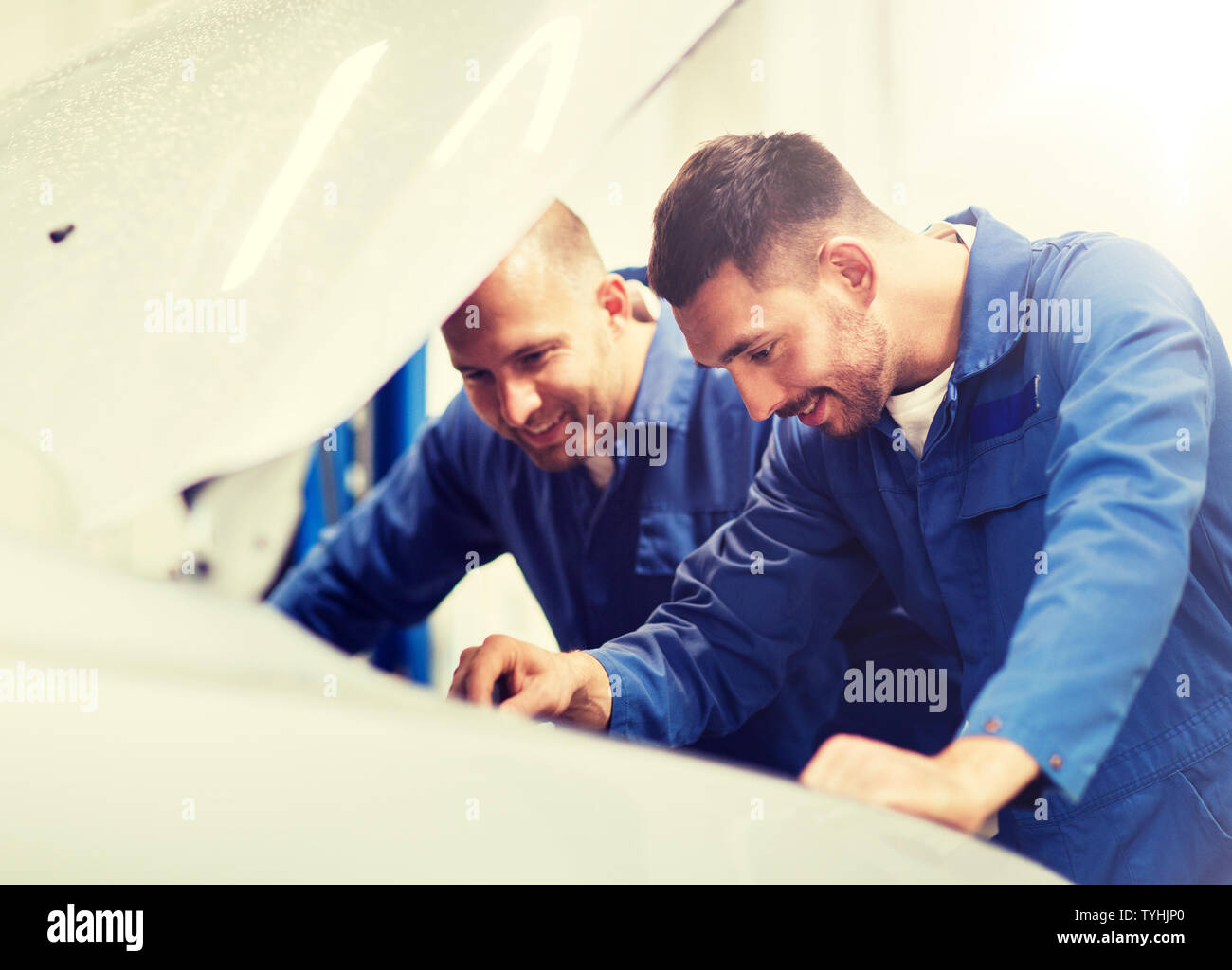 mechanic men with wrench repairing car at workshop Stock Photo - Alamy
