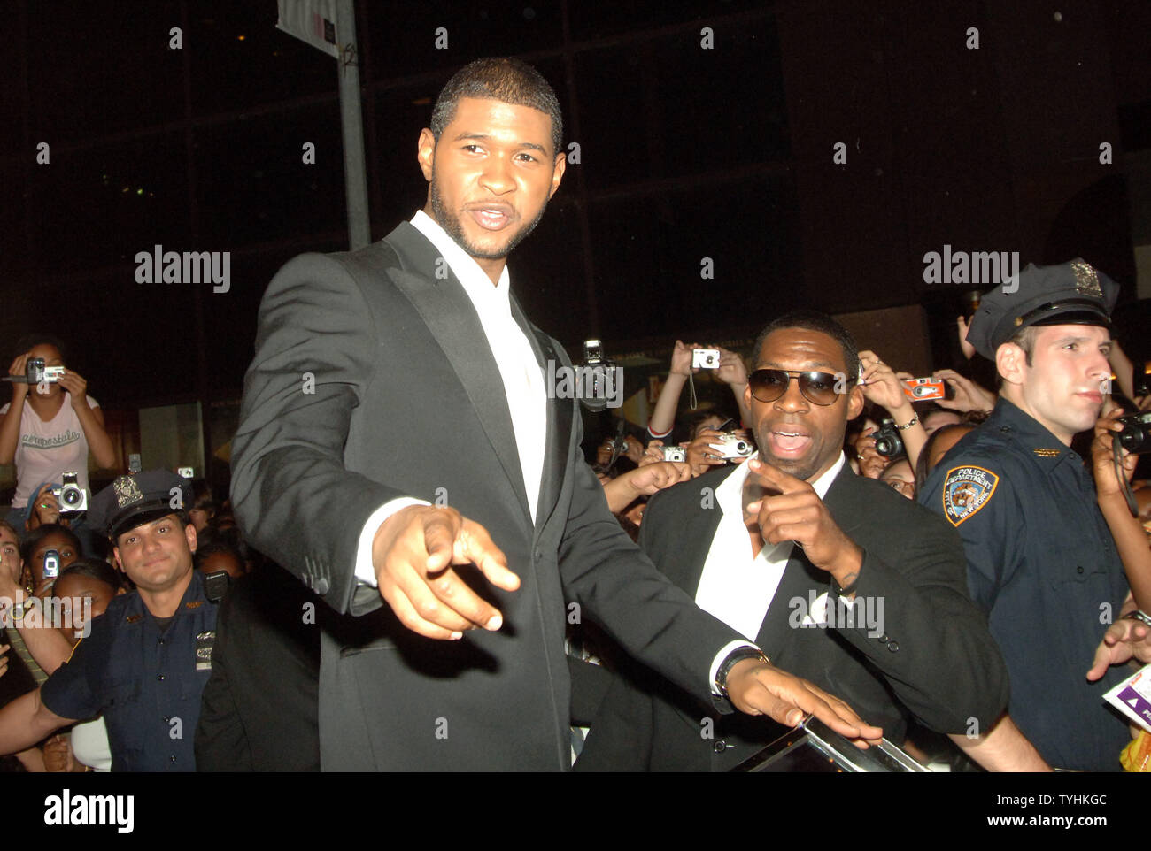 R & B singer Usher greets fans gathered outside the Ambassador theatre ...