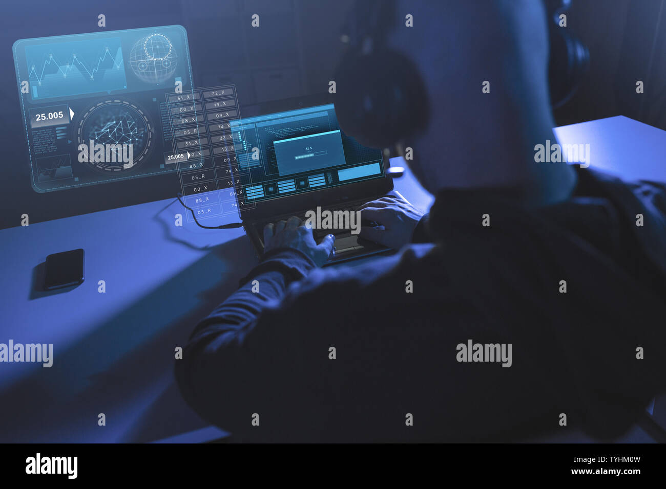 hacker with progress bar on laptop in dark room Stock Photo - Alamy