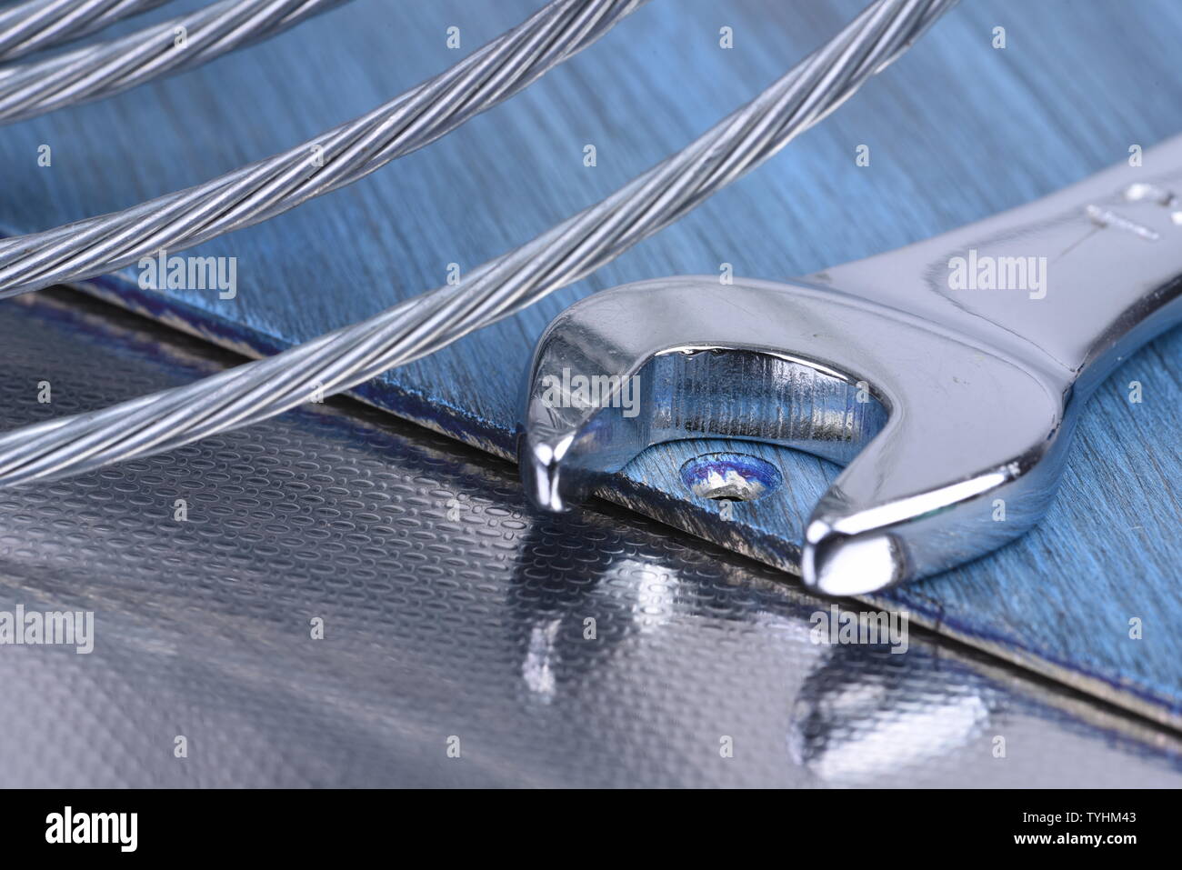 Wrench tool and steel rope, construction equipment on metallic ...