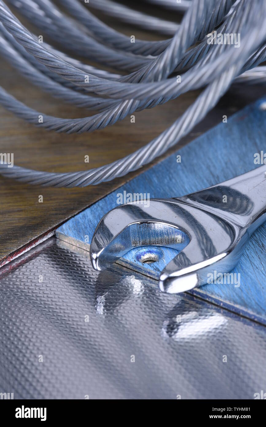 Wrench tool and steel rope, construction equipment on metallic ...